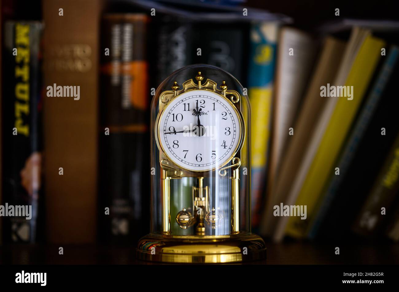 Old golden clock and books Stock Photo - Alamy
