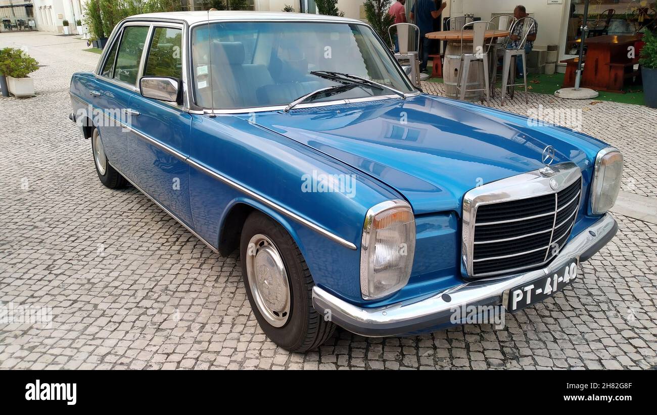 Blue classic 1960s-1970s W-class Mercedes-Benz sedan, parked on a ...