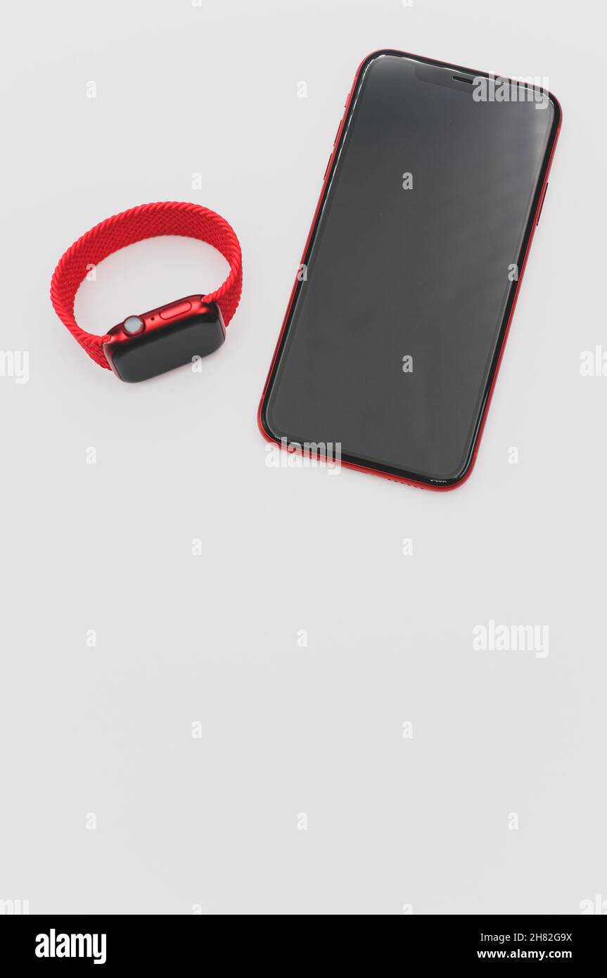 INVERIGO, ITALY - Nov 25, 2021: Apple watch product red and iphone on a ...