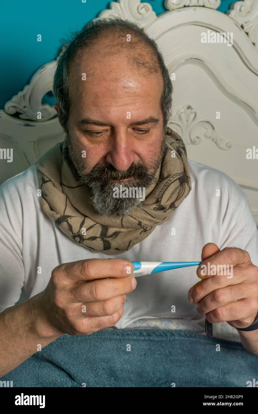 sick man in bed with fever Stock Photo - Alamy