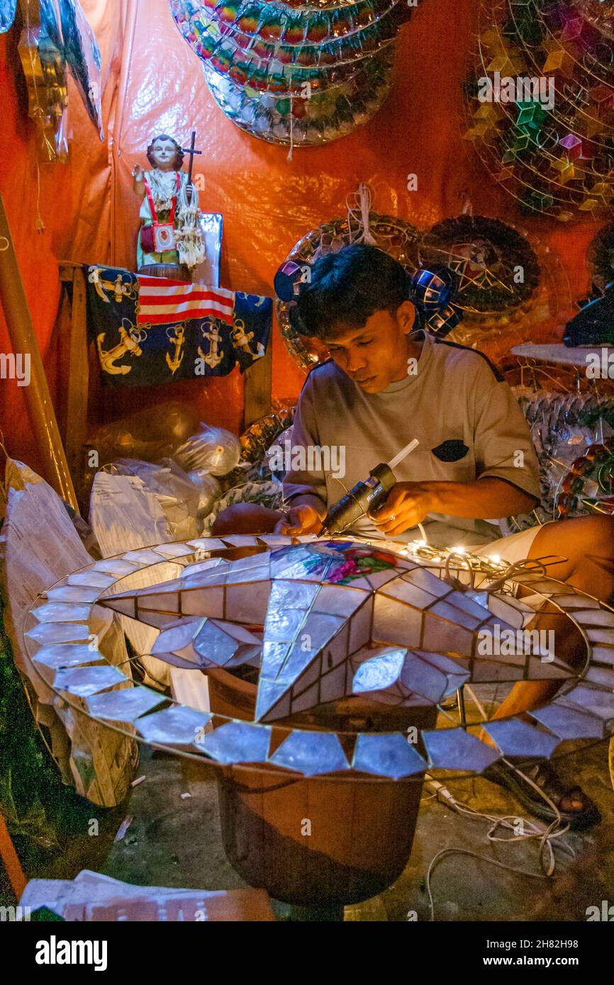 Filipino lantern maker working on a 'parol,' the traditional Christmas ...