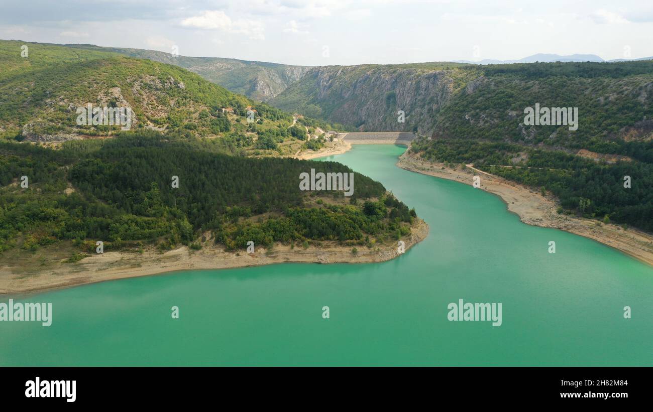Aerial view of a beautiful landscape with a lake surrounded by cliffs ...