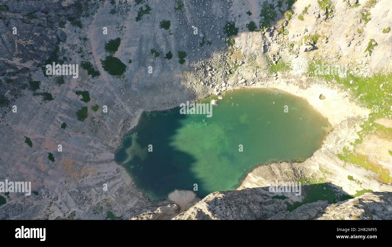 Aerial view of a beautiful landscape with a lake surrounded by cliffs ...
