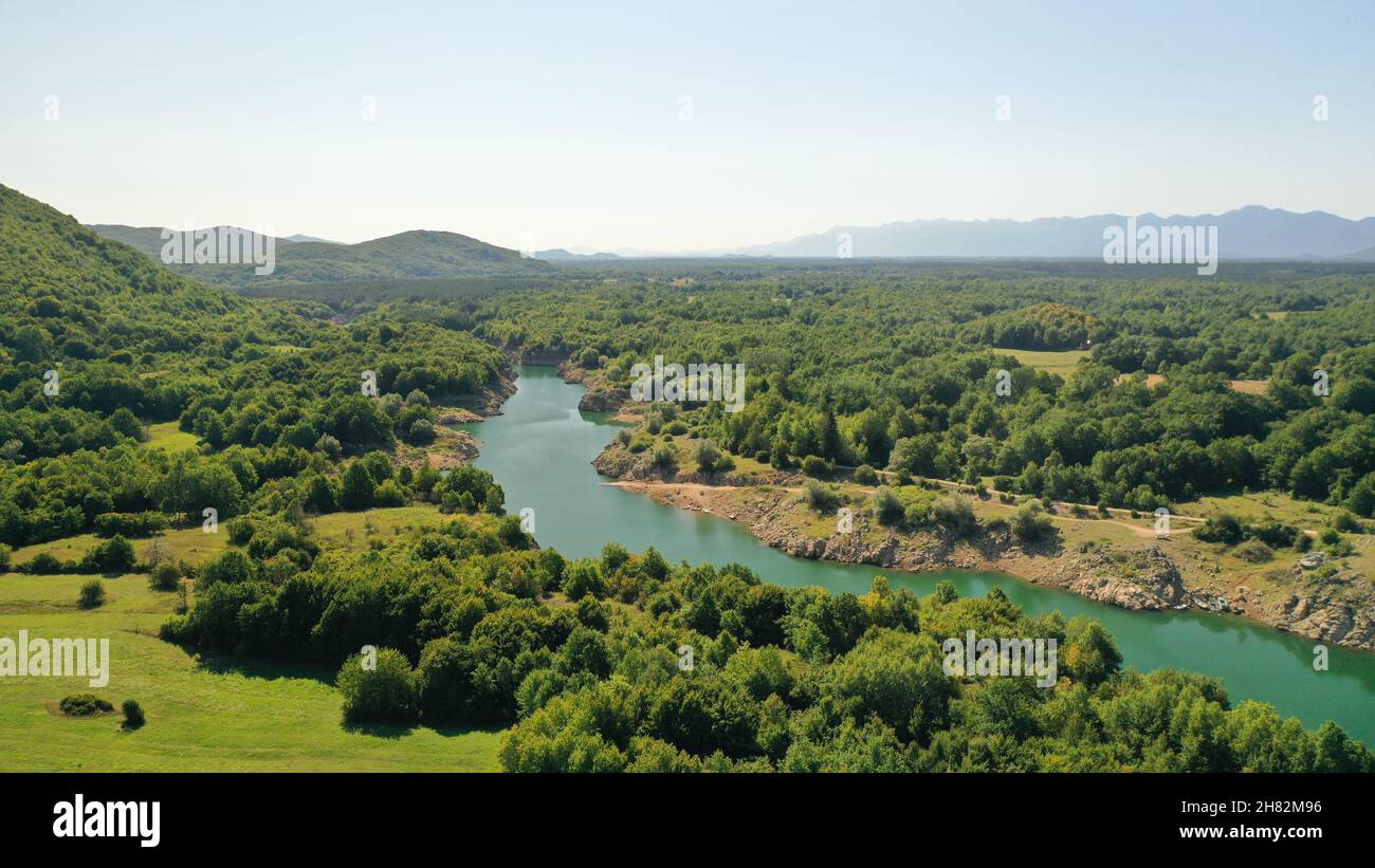 Aerial view of a beautiful landscape with a lake surrounded by cliffs ...