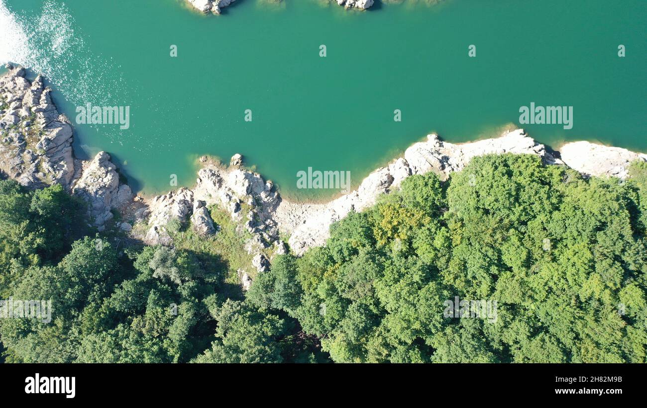 Aerial view of a beautiful landscape with a lake surrounded by cliffs ...