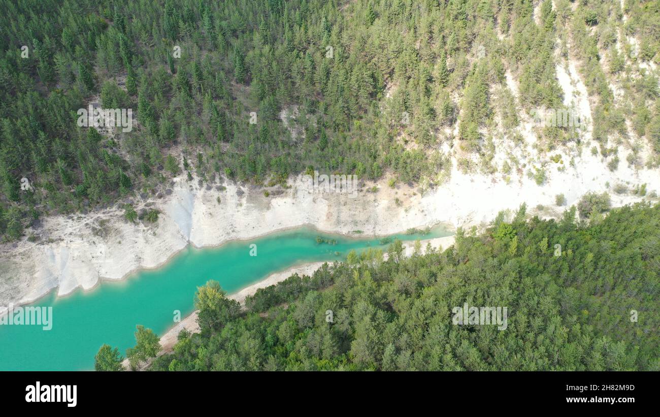 Aerial view of a beautiful landscape with a lake surrounded by cliffs ...