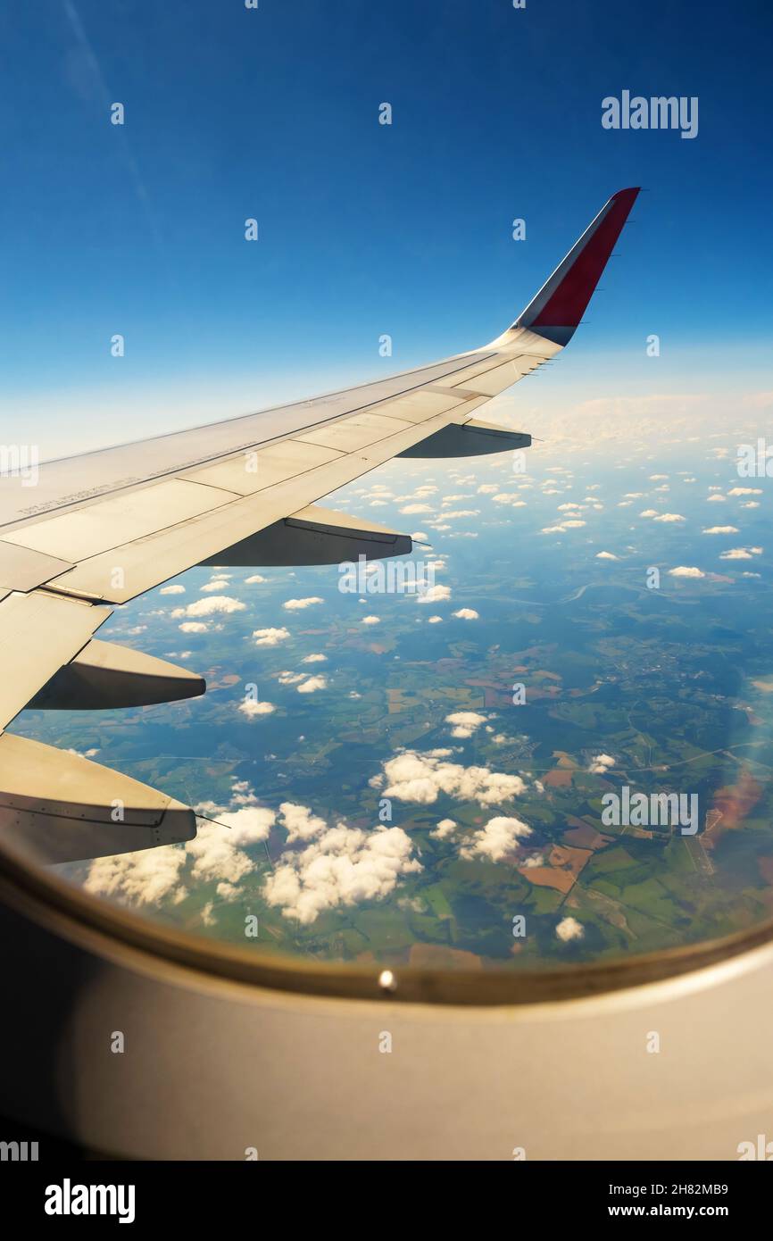 Classic image through aircraft window onto wing. Flight view over ...