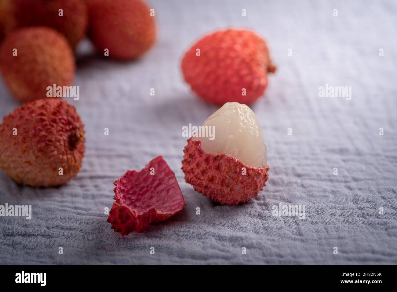 Close-up shot of Lychee fruits on a blue fabric.Good for the menu Stock ...