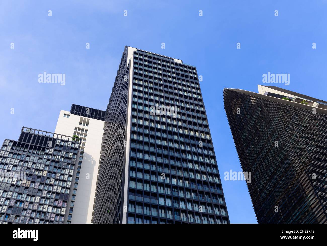 Modern tower buildings or skyscrapers in financial district with blue ...
