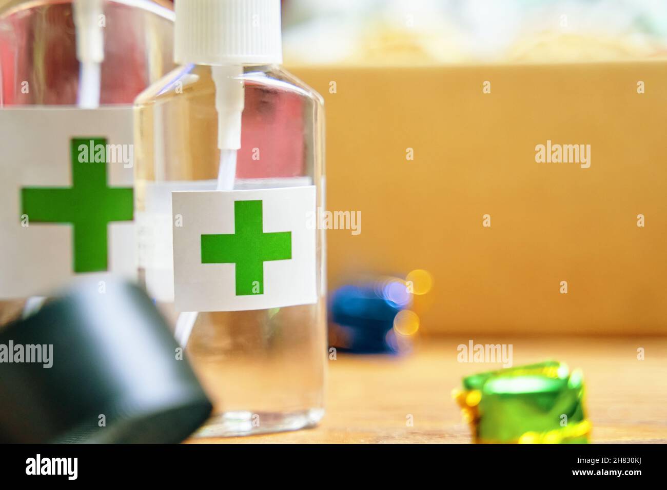 Two antiseptics with red cross logo on wooden table. Concept of hand ...