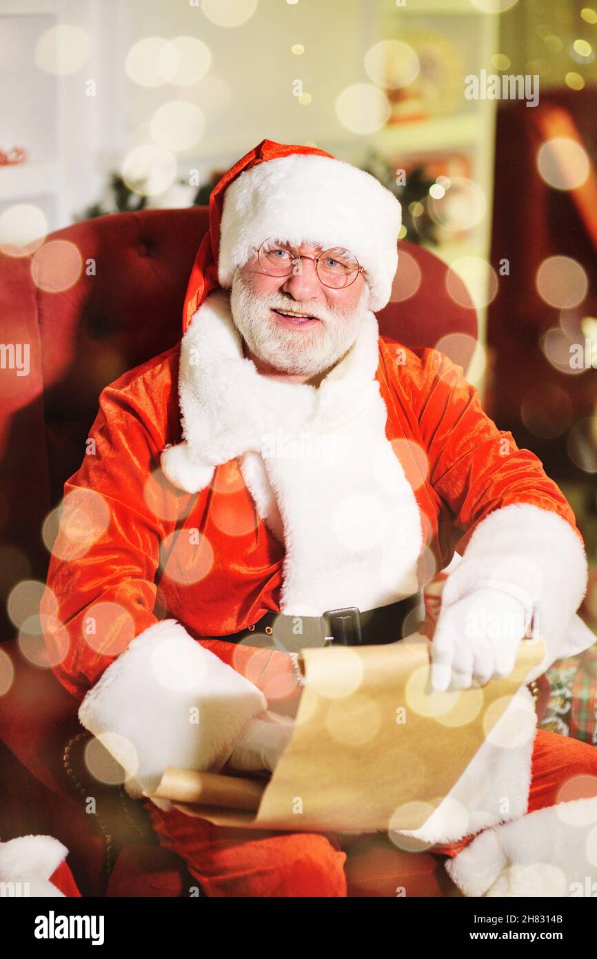 Santa Claus with a real white beard in a traditional red and white suit ...
