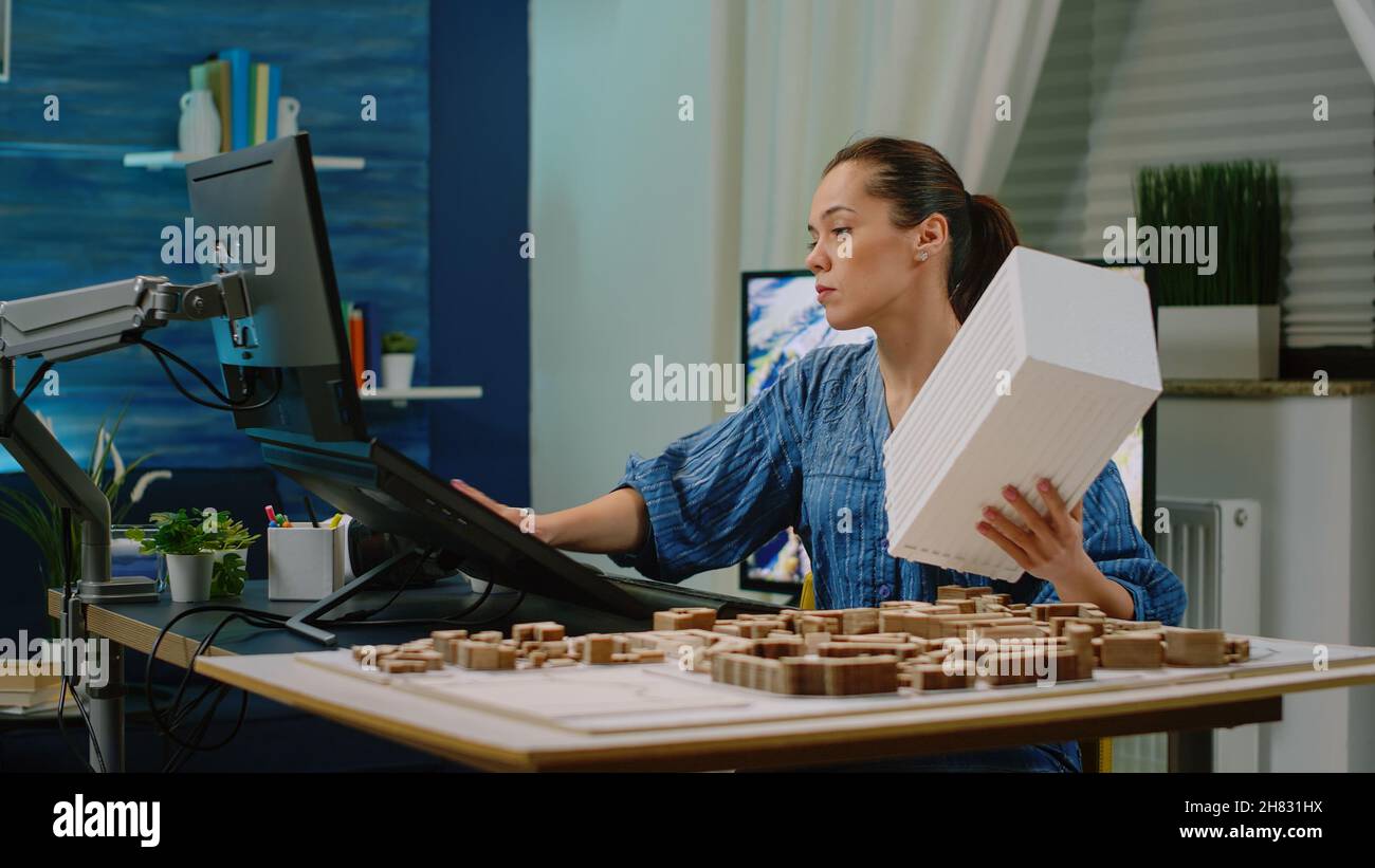 Architect Analyzing Maquette For Architectural Development Woman Engineer Using Building Model