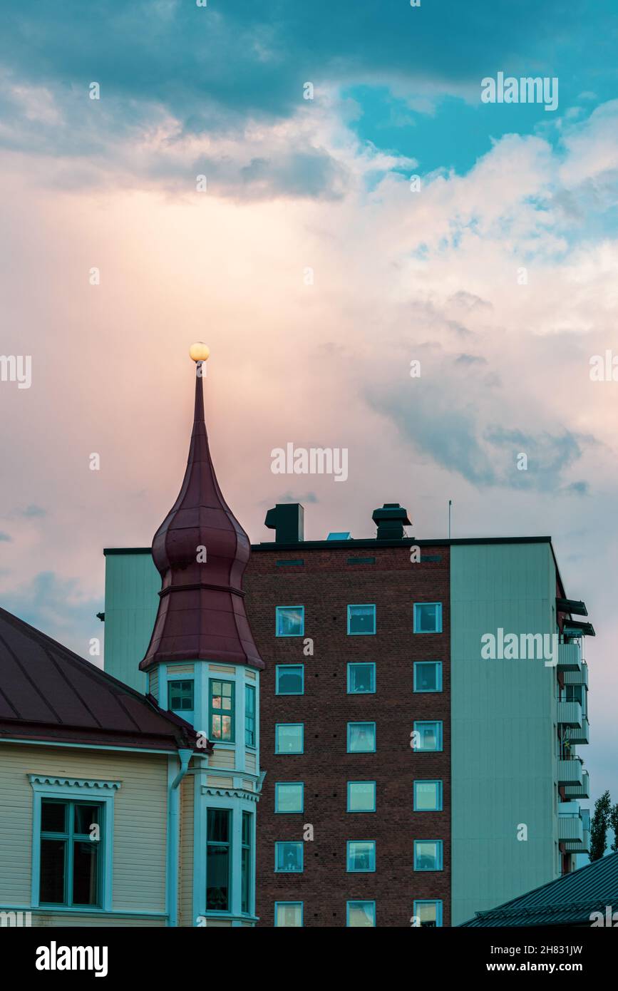 Building with tower in front of other buildings in city Stock Photo - Alamy