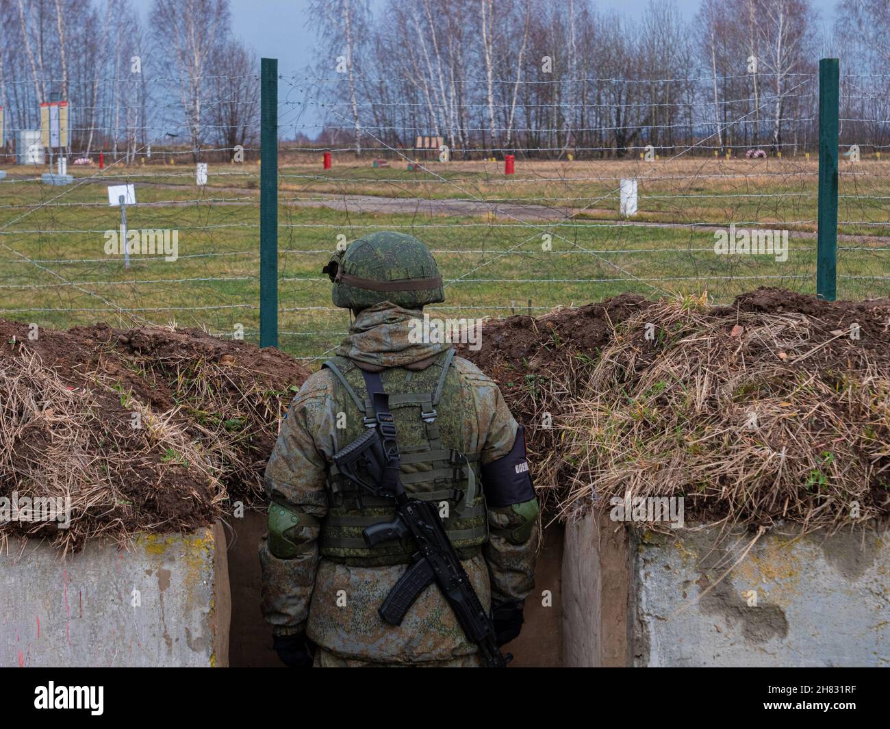 A soldier on duty in a trench at a peacekeeping post. The line of ...