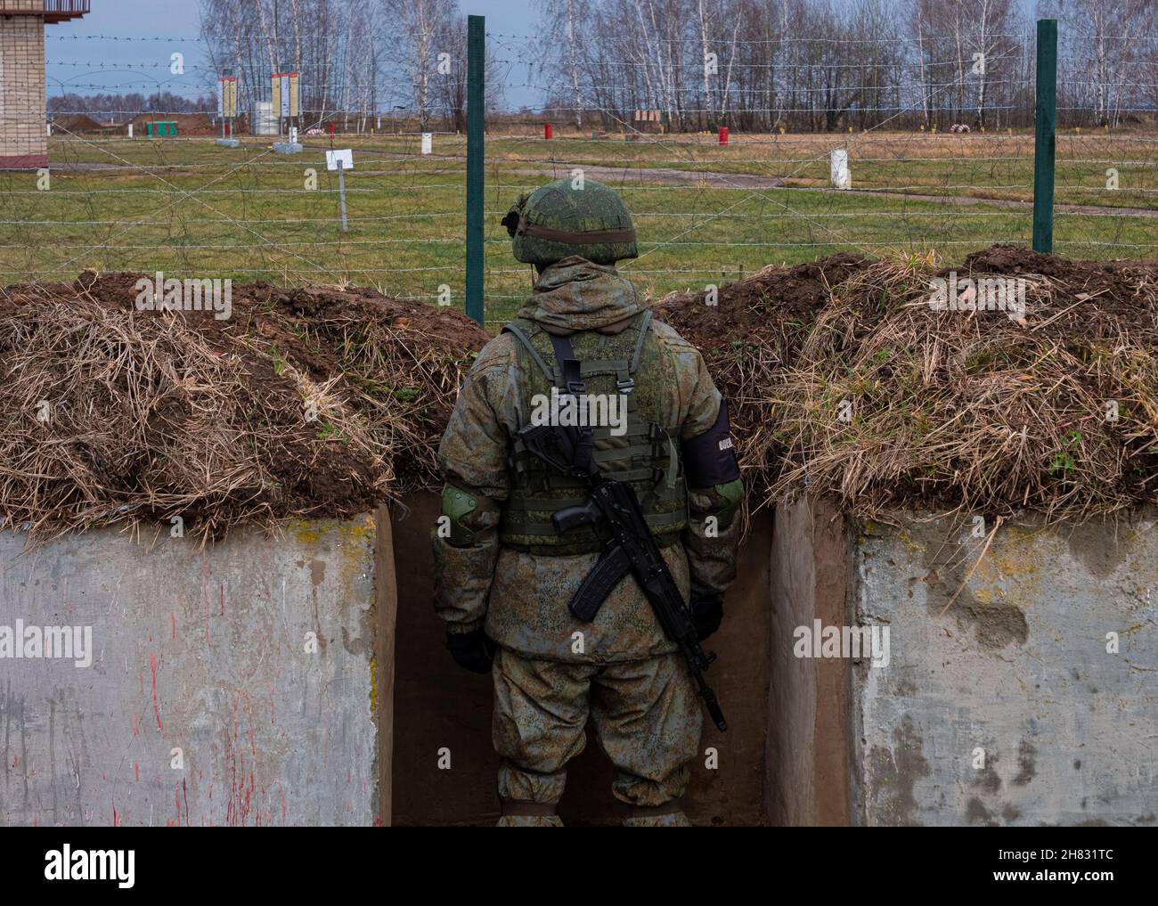 A soldier on duty in a trench at a peacekeeping post. The line of ...