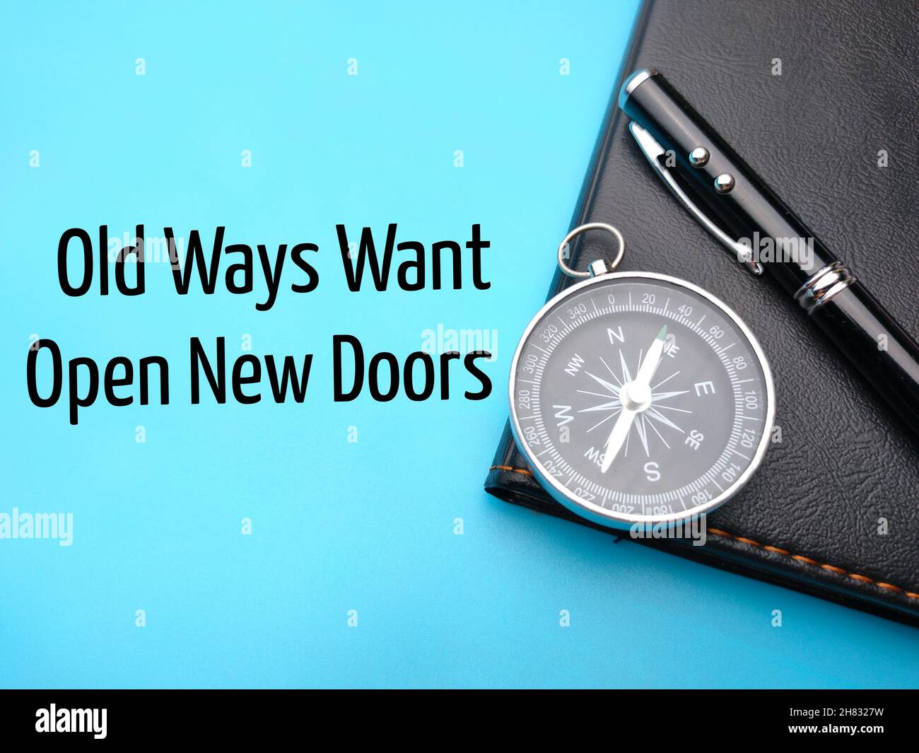 Compass,pen and notebook with text Old Ways Want Open New Doors on a ...