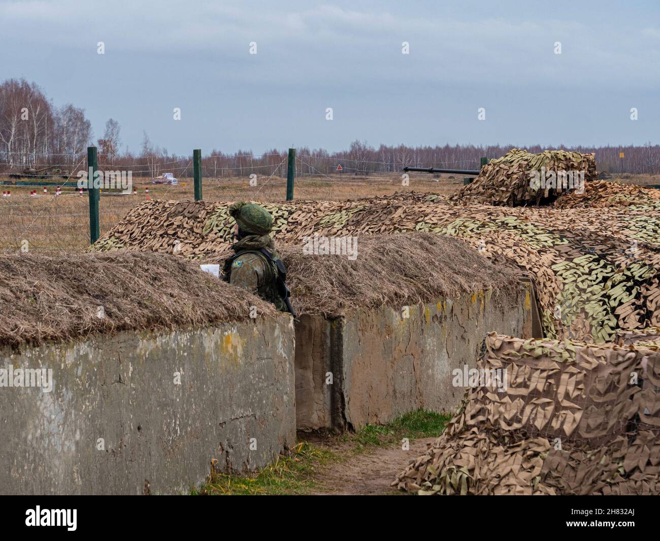 A soldier on duty in a trench at a peacekeeping post. The line of ...