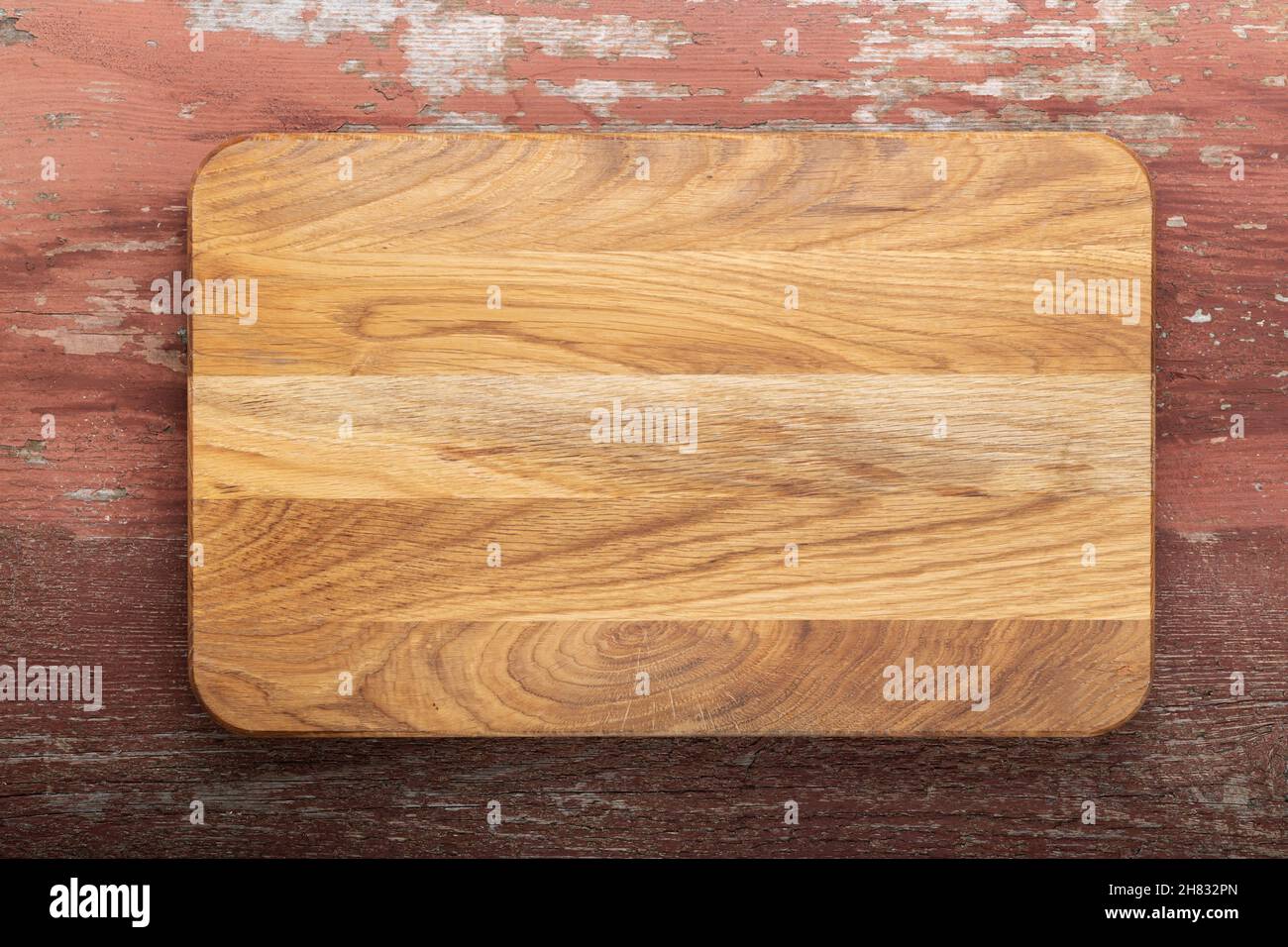 Cutting board on a wooden kitchen table. Space for text. Top view Stock ...