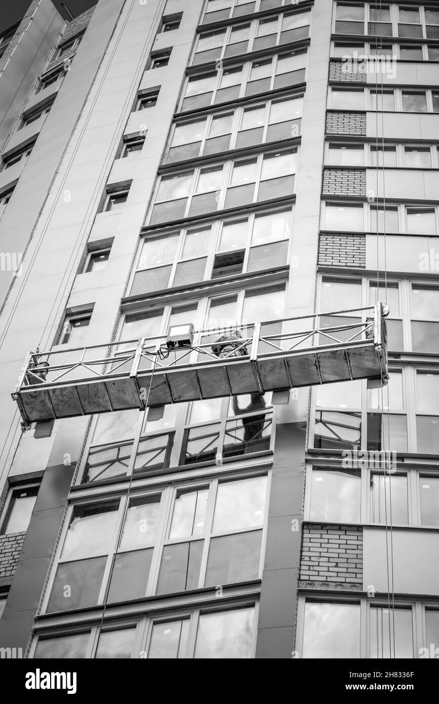 Building cradle on the facade of the building under construction Stock ...
