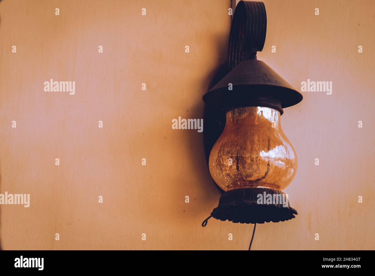 Electrical lamp attached to a brown wall Stock Photo - Alamy