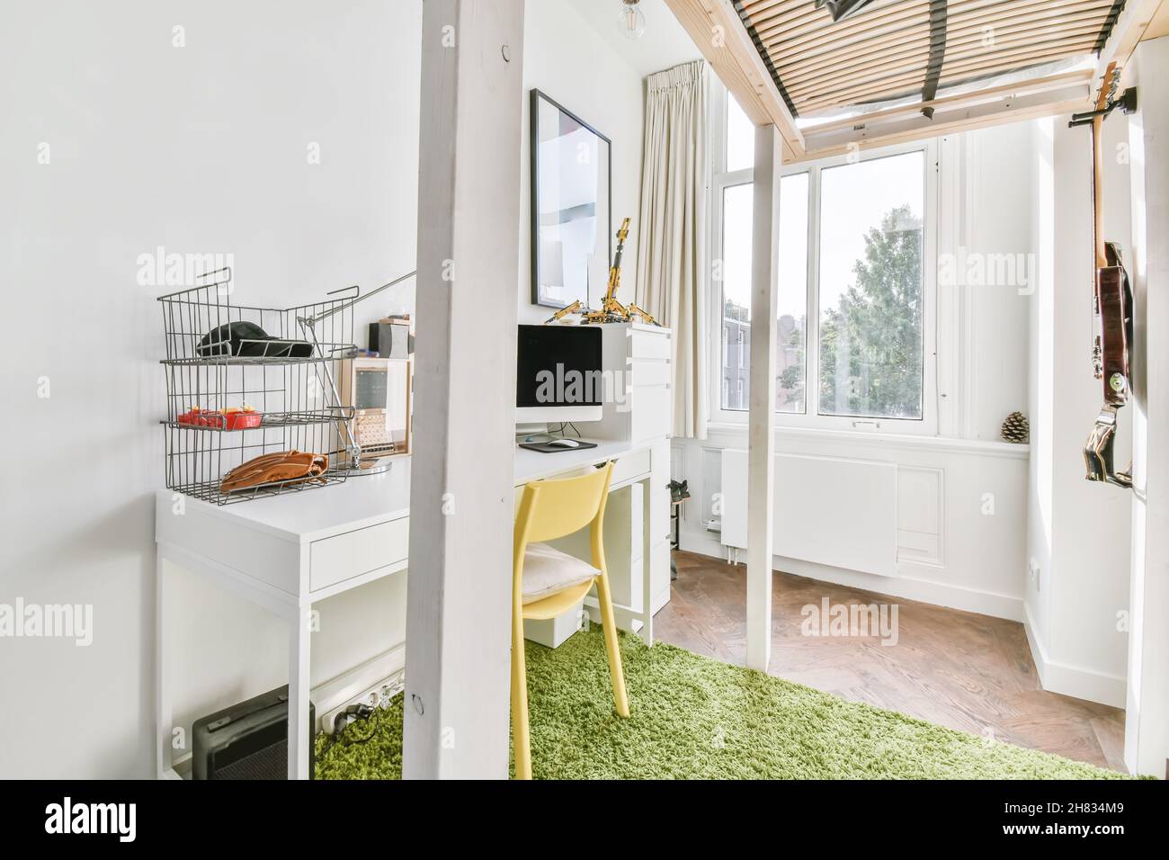 Cozy work room with artificial turf and a window opposite Stock Photo ...