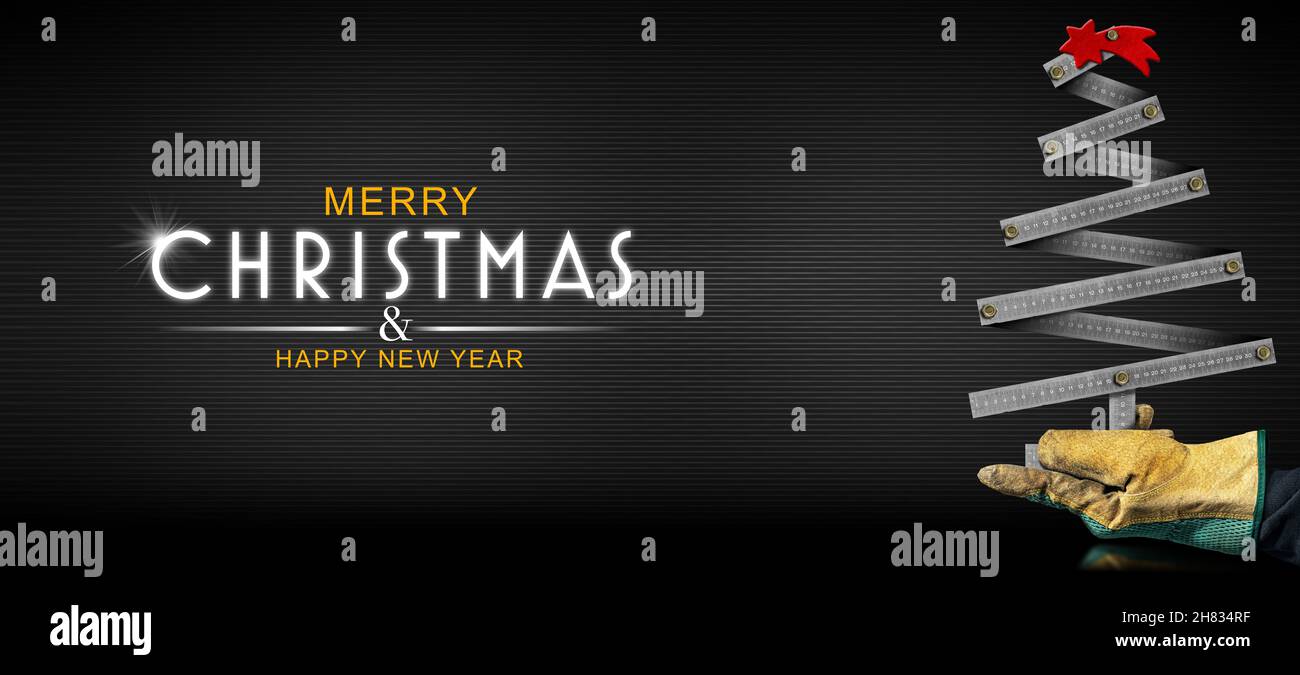 Hand with protective work glove holding a small metallic ruler in the ...