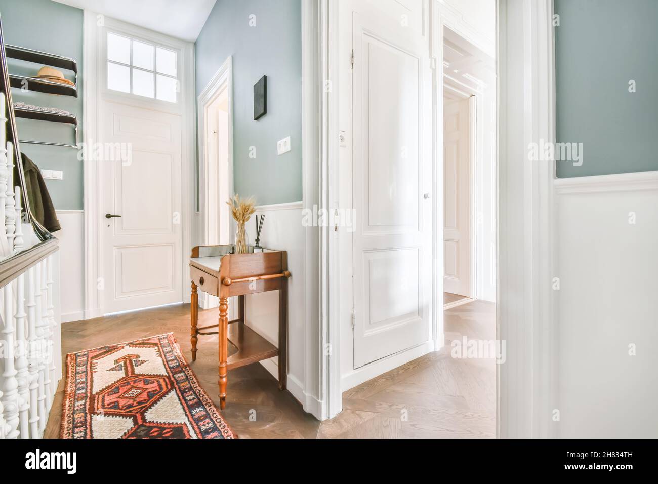 Light blue corridor with a wooden chest of drawers on high legs Stock ...