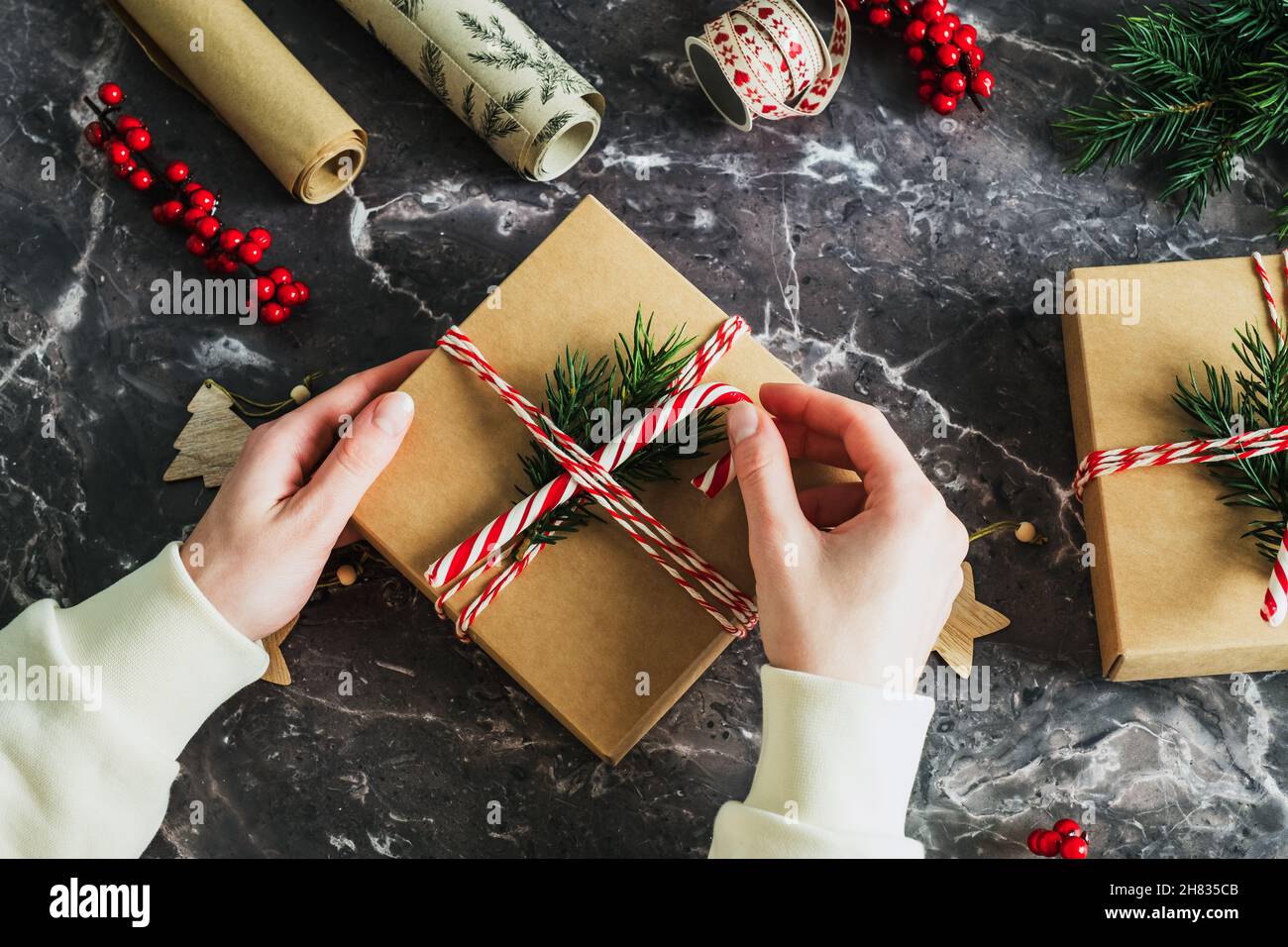 Christmas preparation concept. Female hands wrapping Christmas gift box ...