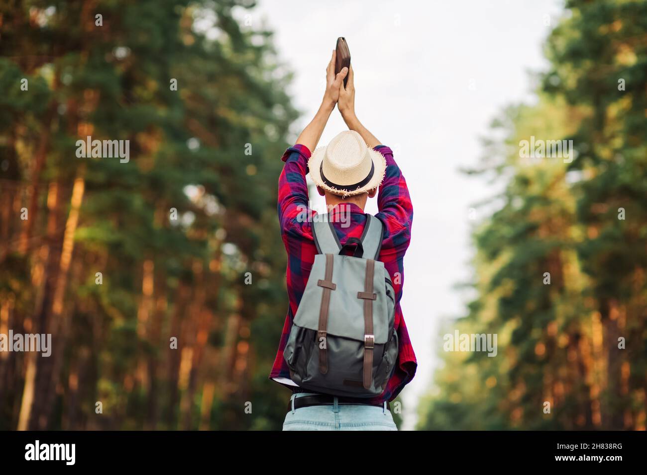 Christian man raised his Bible up while standing outdoors. Reading the ...