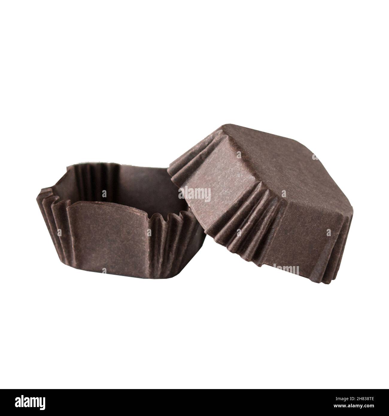 Brown paper cupcake forms for baking isolated over white background ...