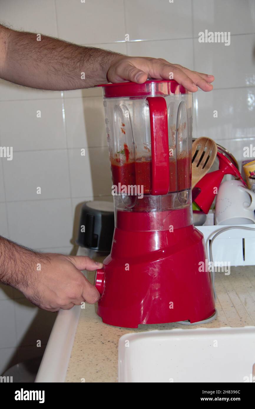 Man making a tomato sauce on the kitchen counter Stock Photo - Alamy