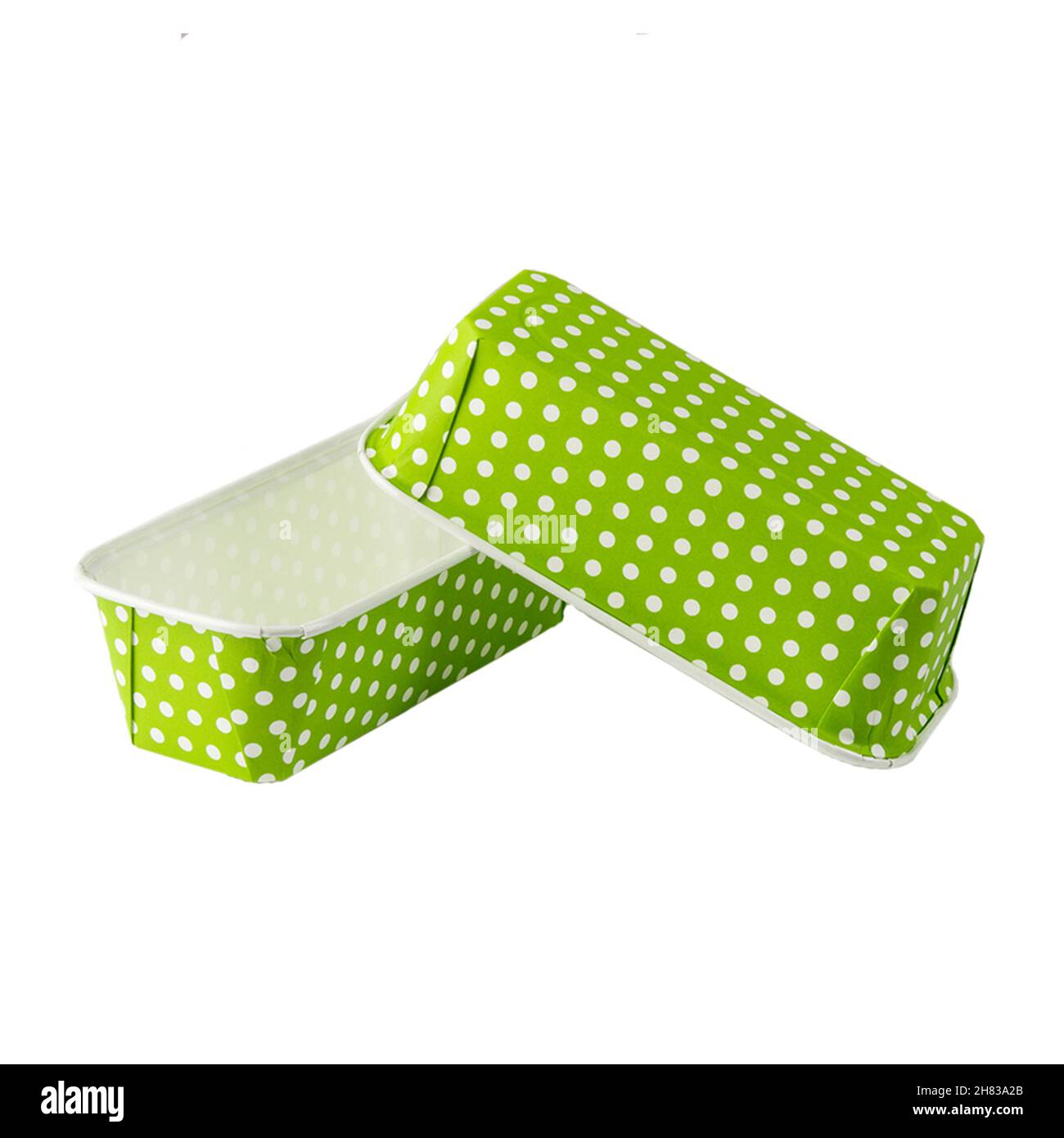Green paper baking forms for cakes with dotted pattern isolated over ...
