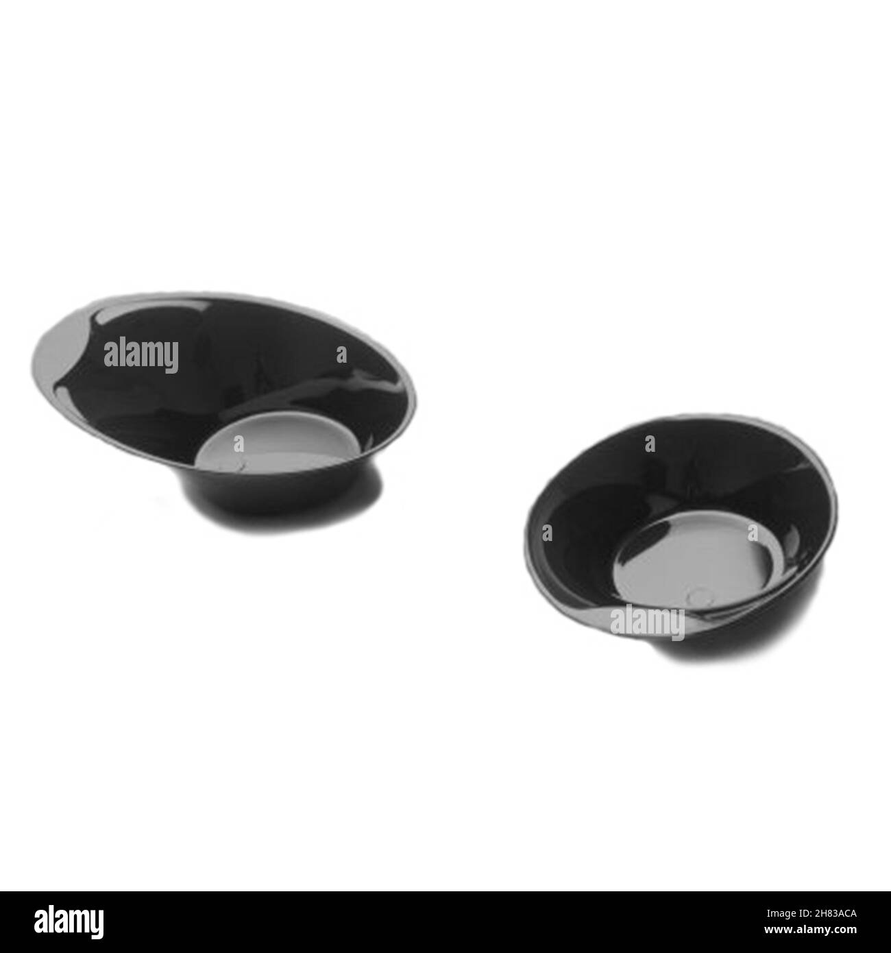 Two black plastic cups isolated over white background, confectionery ...