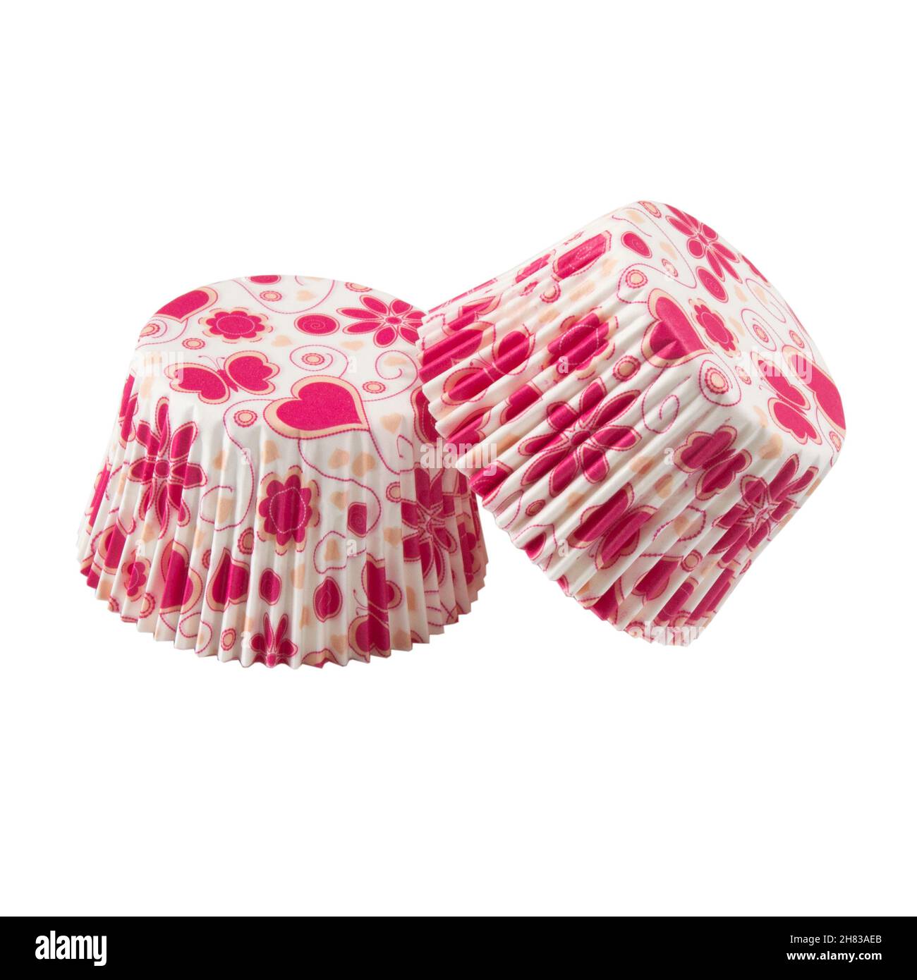 White paper cupcake forms for baking with hearts pattern isolated over ...