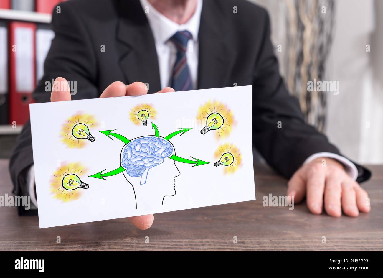 Businessman showing an index card with human brain ideas concept Stock ...