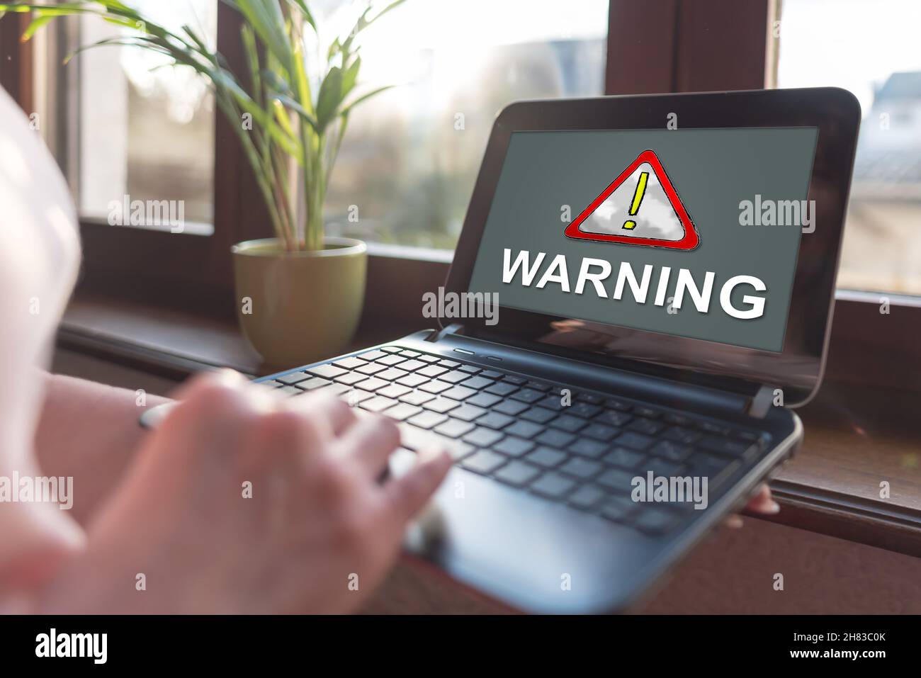 Laptop screen displaying a warning concept Stock Photo - Alamy