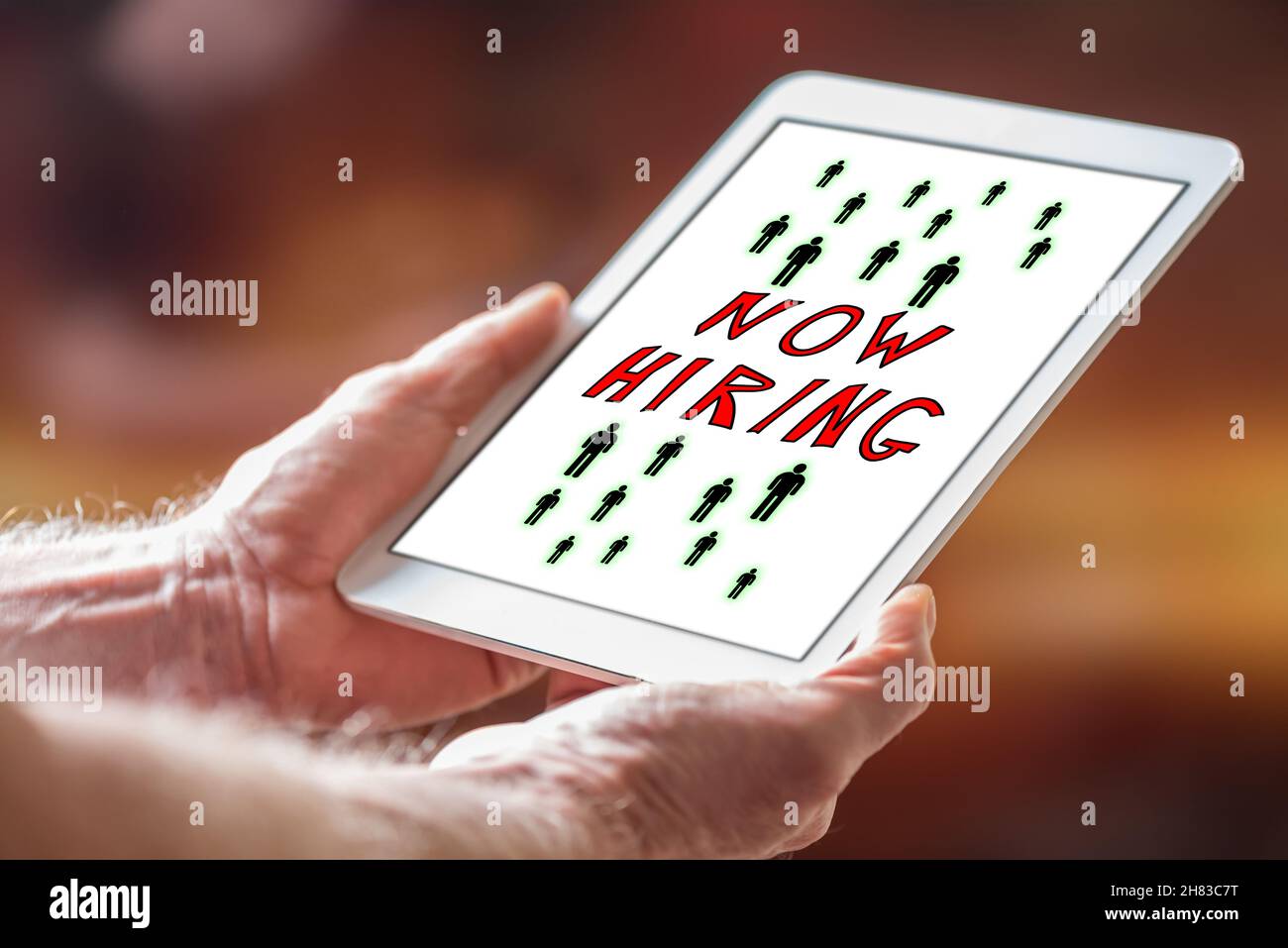 Man holding a tablet showing hiring concept Stock Photo - Alamy
