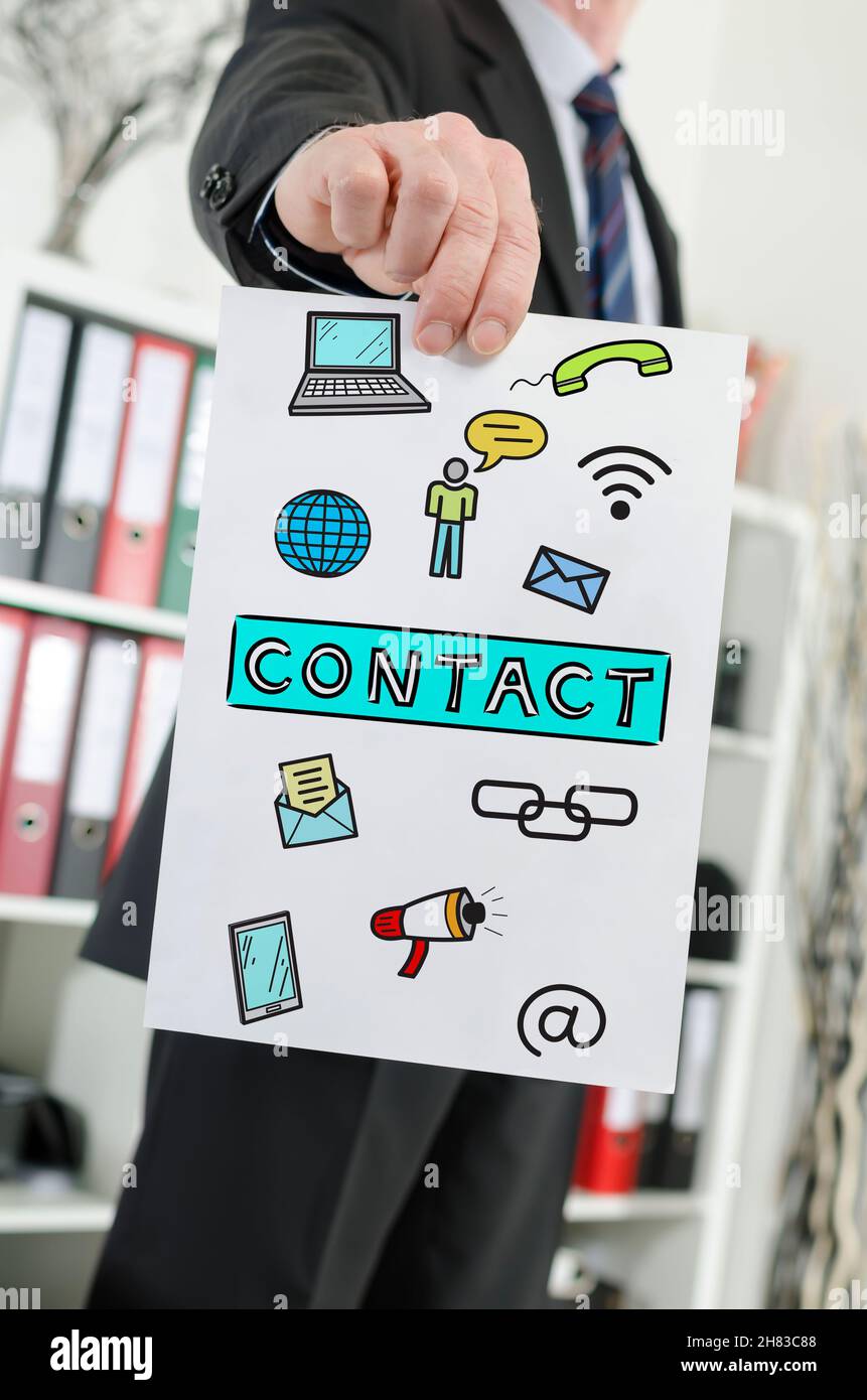 Paper showing contact concept held by a businessman Stock Photo - Alamy