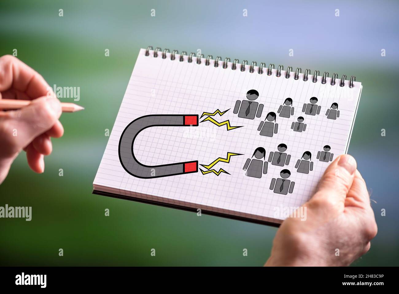 Hand drawing customer attraction concept on a notepad Stock Photo - Alamy