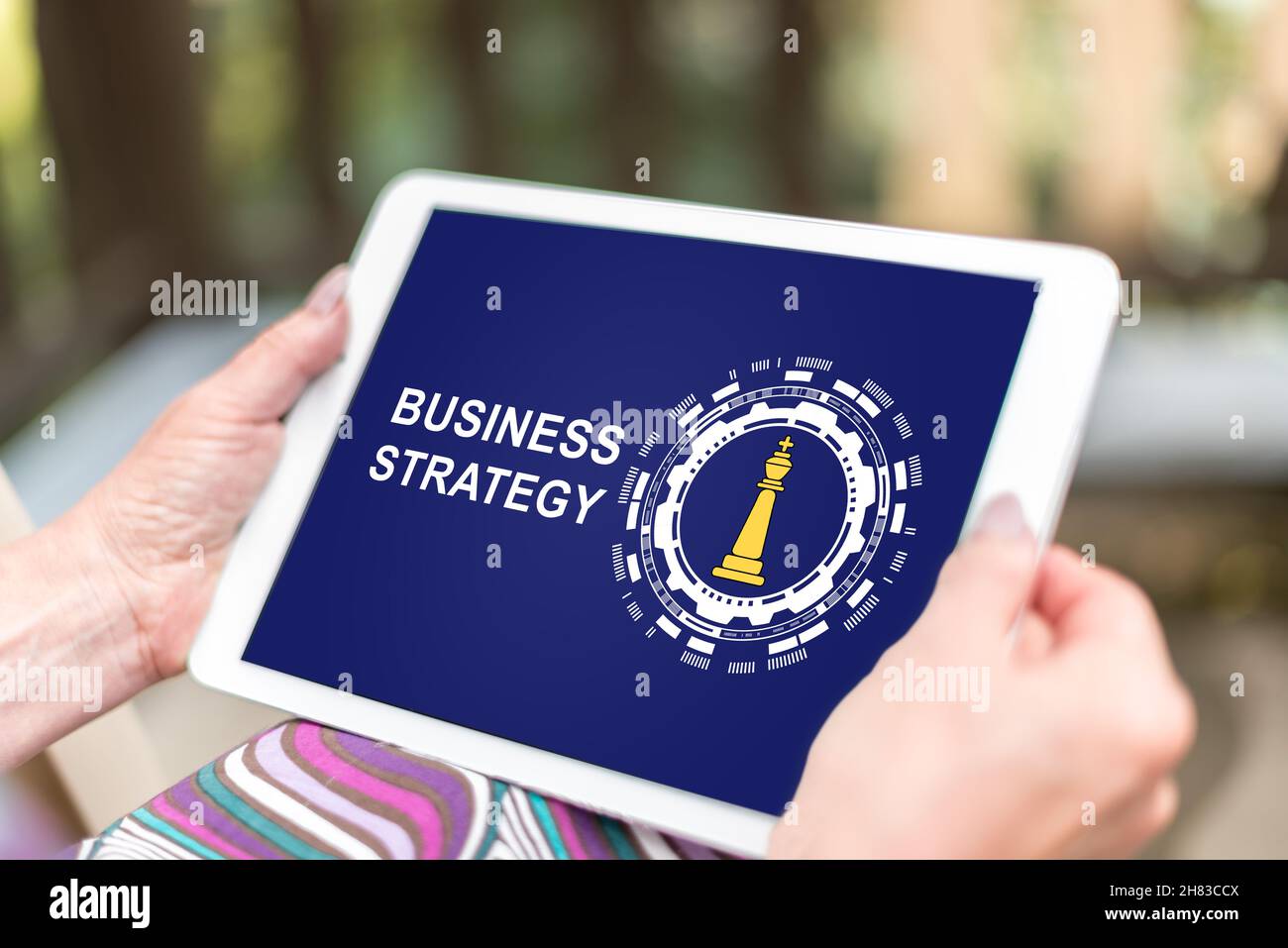 Female hands holding a tablet with business strategy concept Stock ...