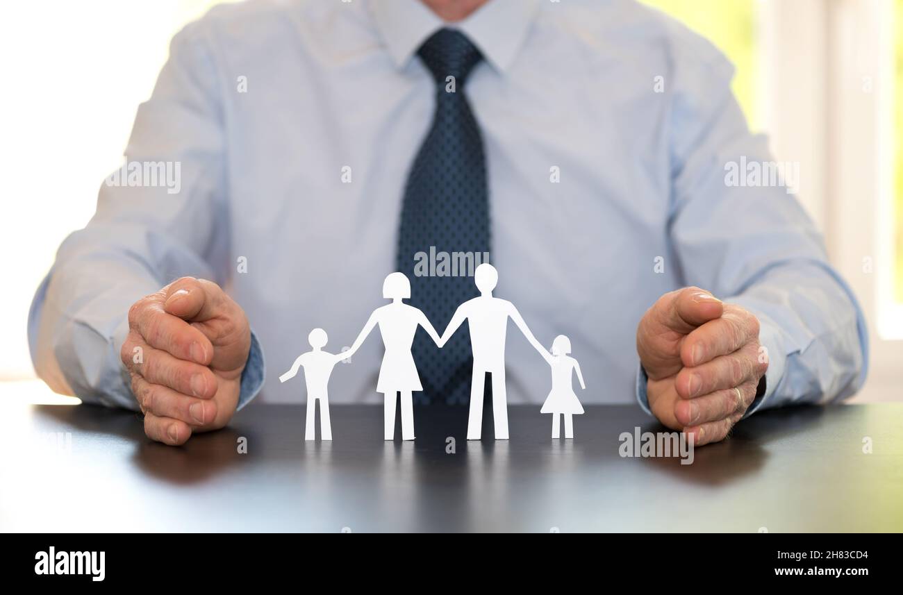 Insurer protecting a family with his hands Stock Photo - Alamy