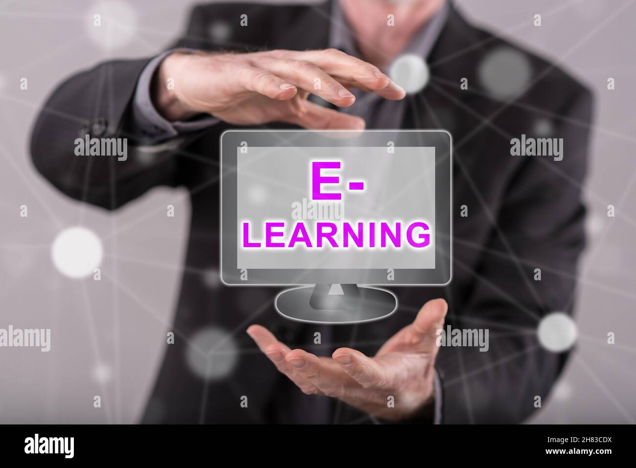 E-learning concept between hands of a man in background Stock Photo - Alamy