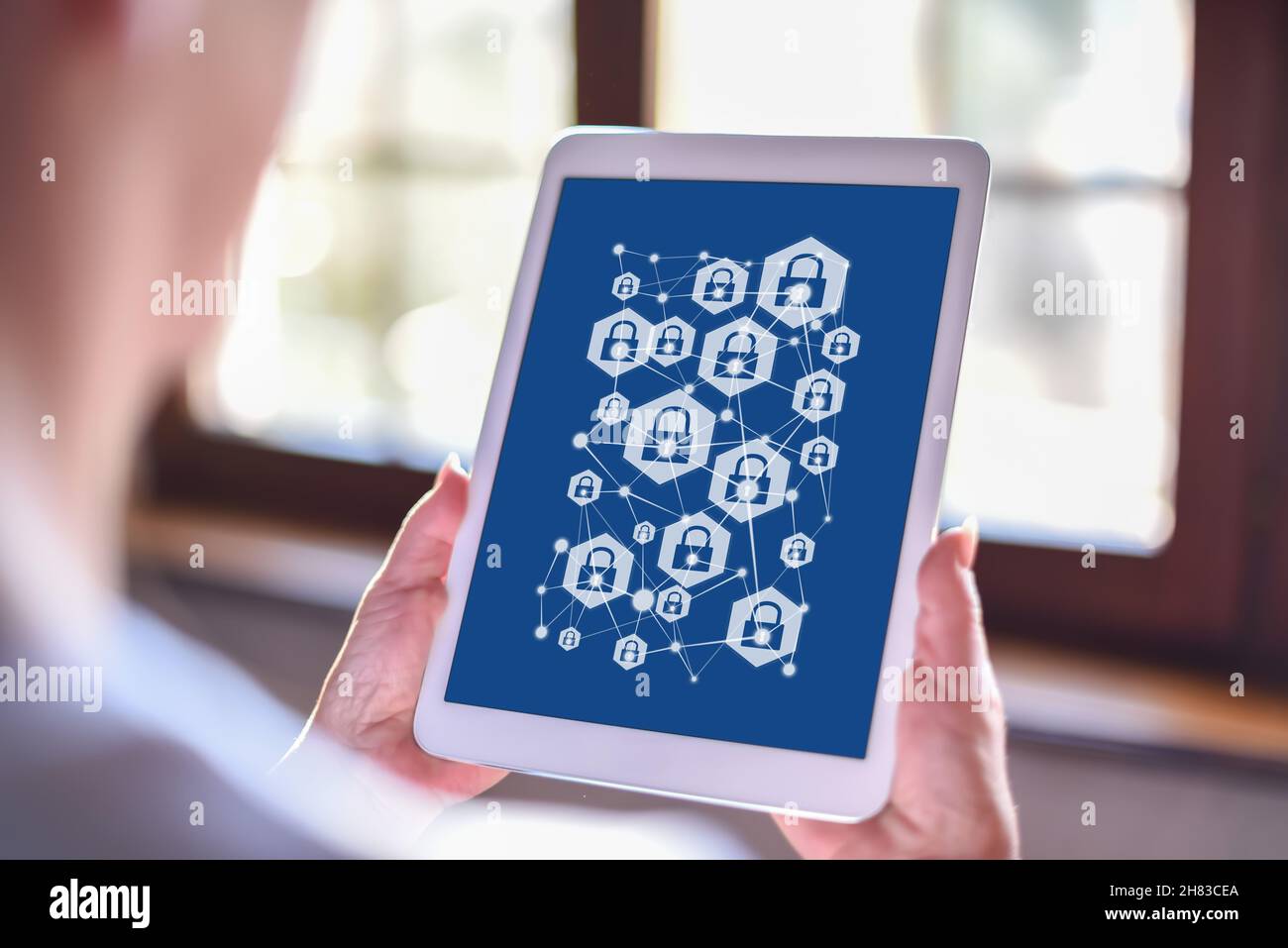 Tablet screen displaying a network safety concept Stock Photo - Alamy
