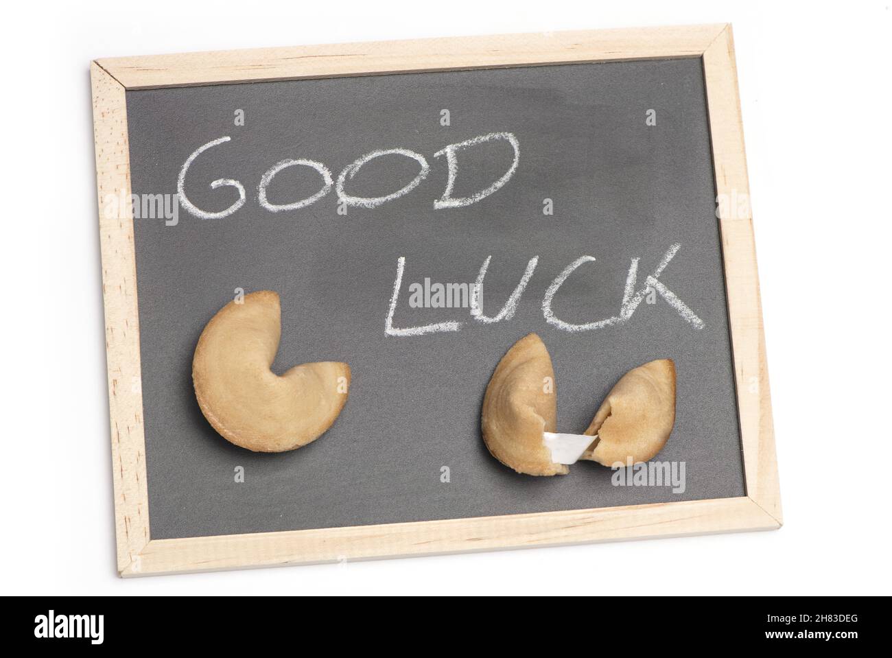 small chalkboard with opened chinese fortune cookie and words good luck ...