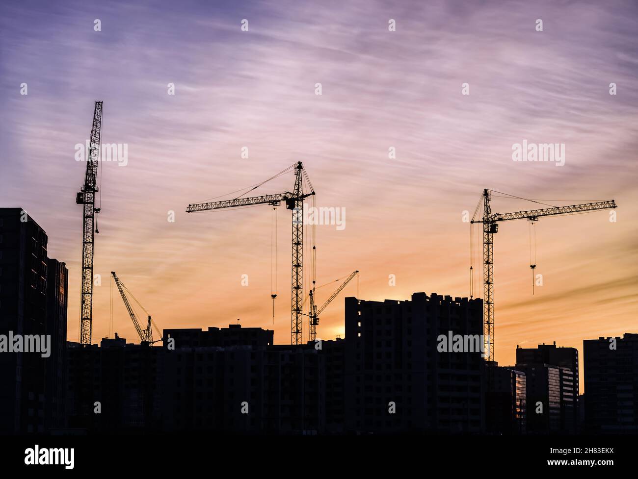 Construction crane against a sunset background Stock Photo - Alamy