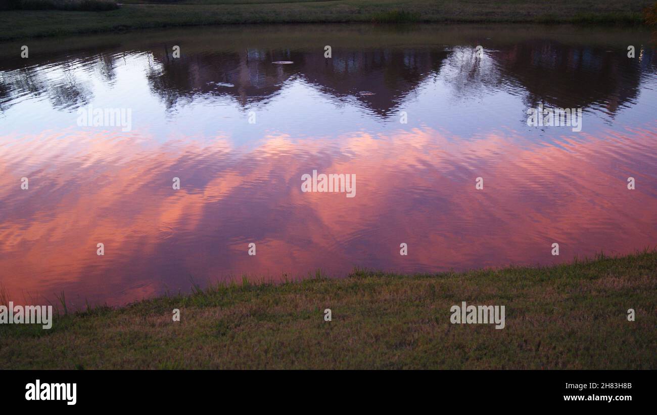 Red sky reflected in the pond. The sky on the Water Stock Photo - Alamy