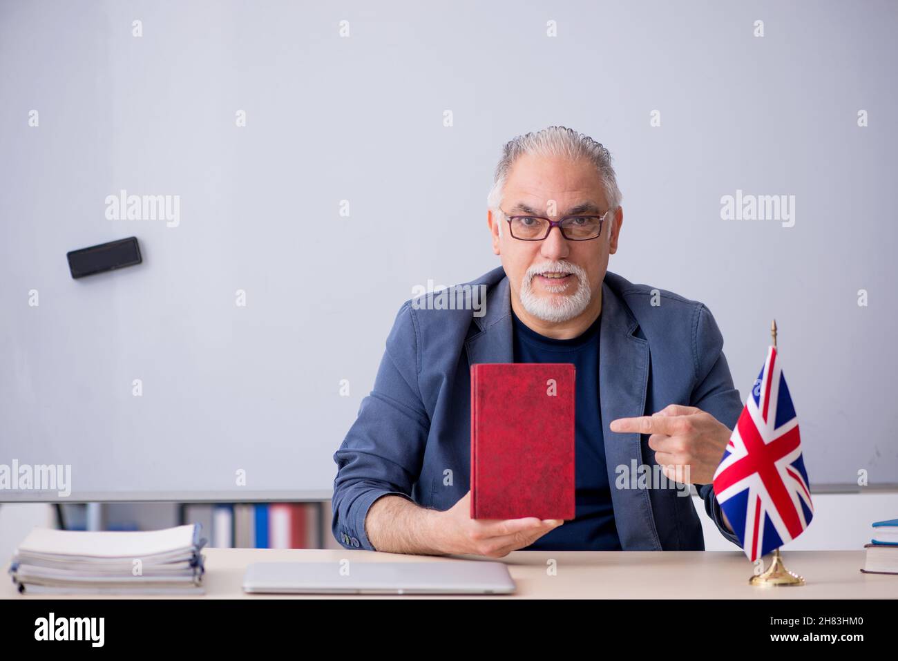 Old english language teacher in the classroom Stock Photo - Alamy