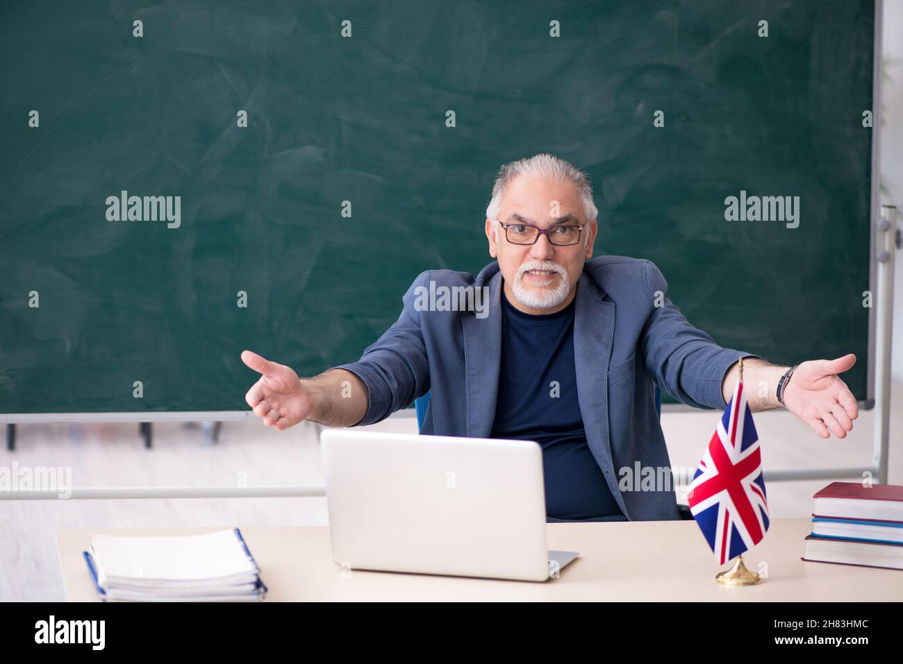 Old english language teacher in the classroom Stock Photo - Alamy