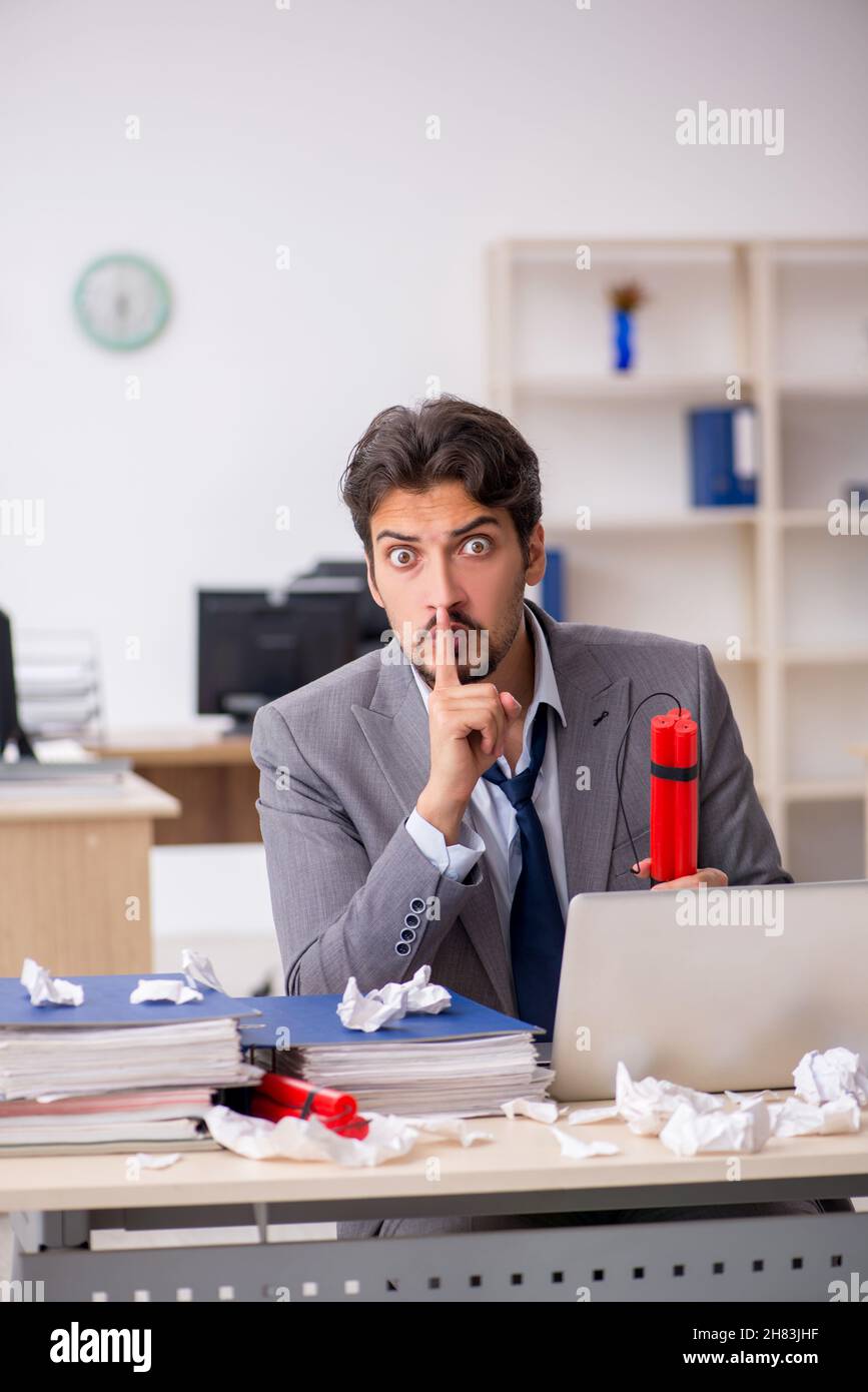 Young employee and too much work in the office Stock Photo - Alamy