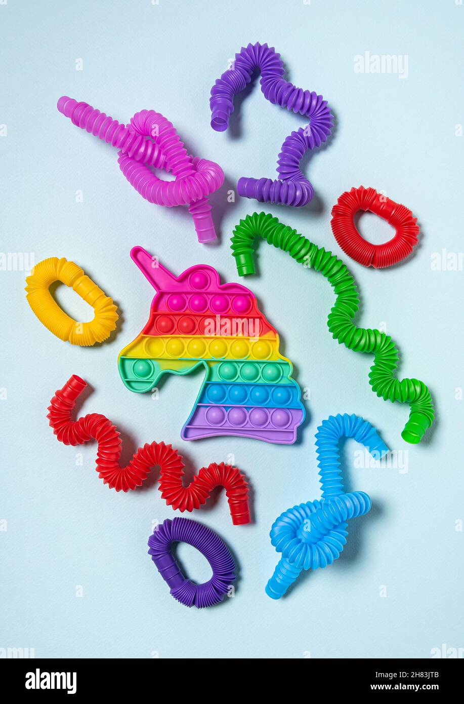 Pink, red, purple, green, blue and yellow pop tube children toys bent ...